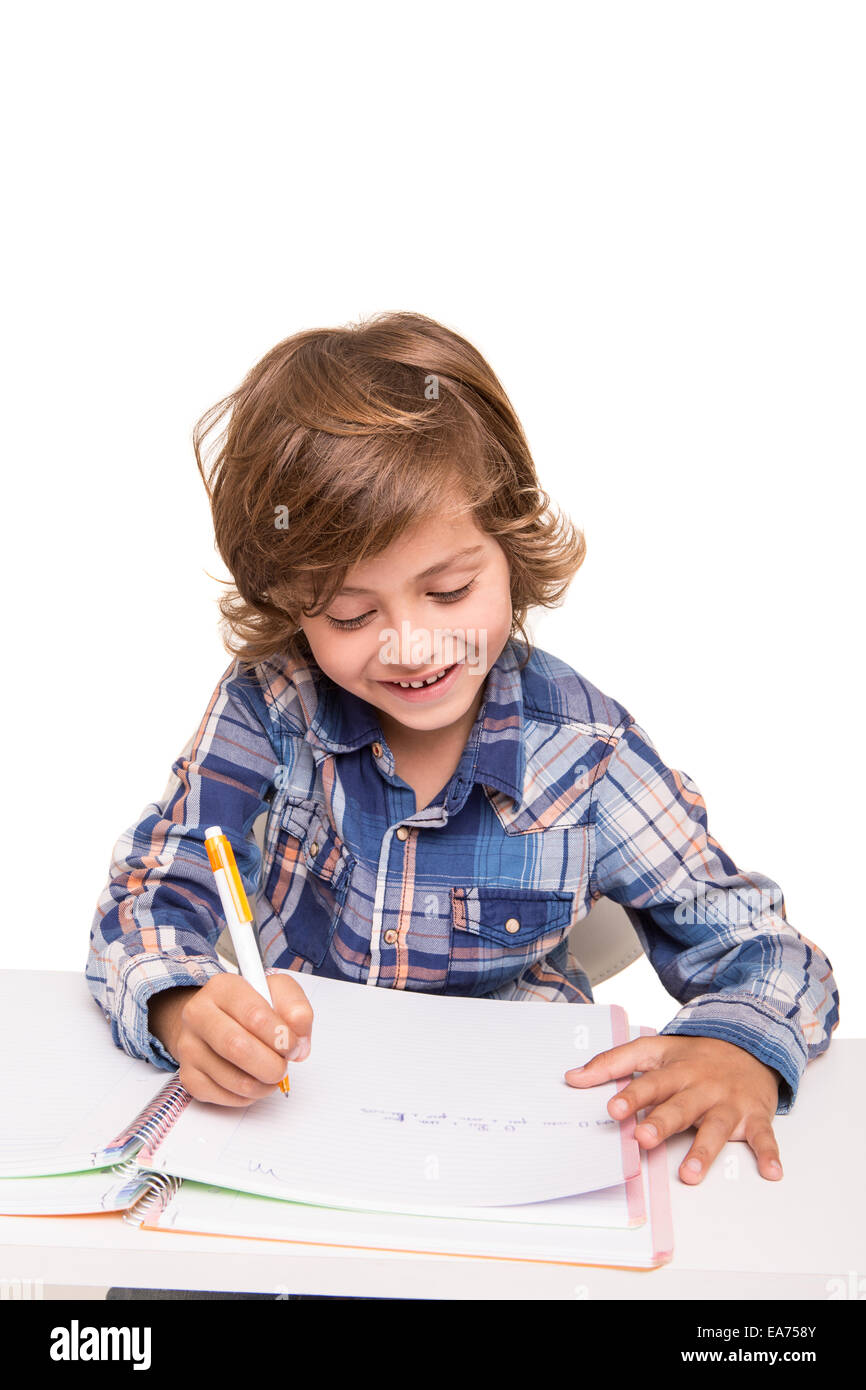 Student boy writing for homework at his desk Stock Photo - Alamy