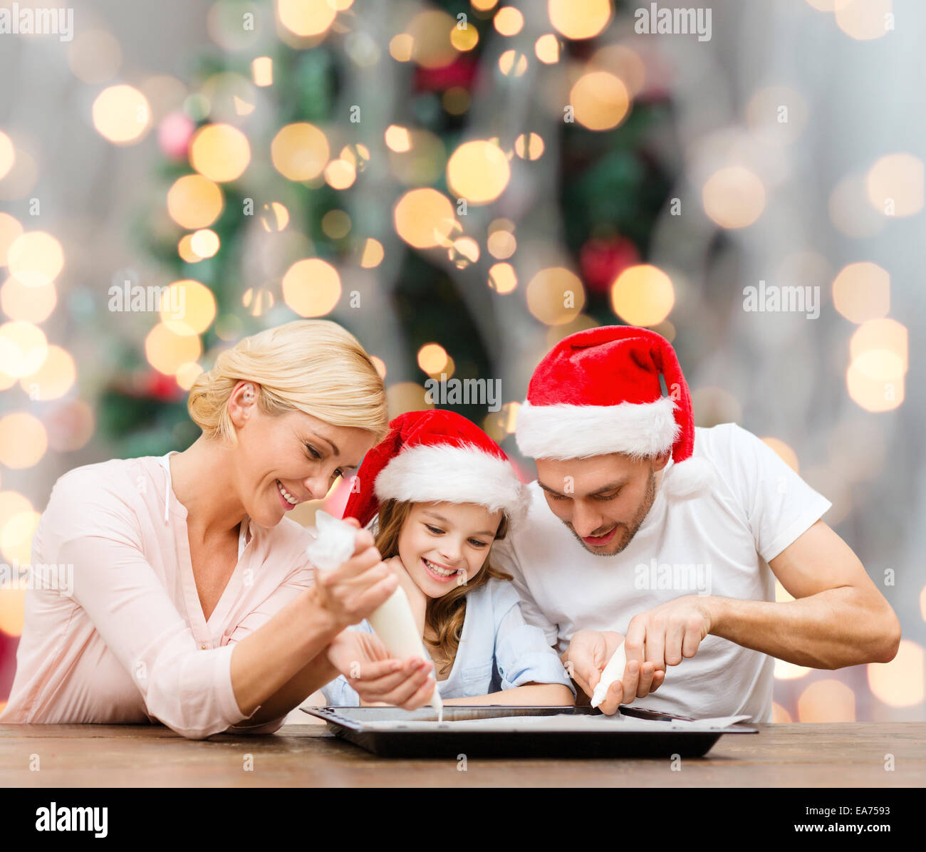 happy family in santa helper hats cooking Stock Photo - Alamy