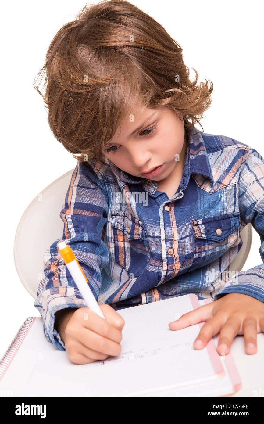 Student boy writing for homework at his desk Stock Photo - Alamy
