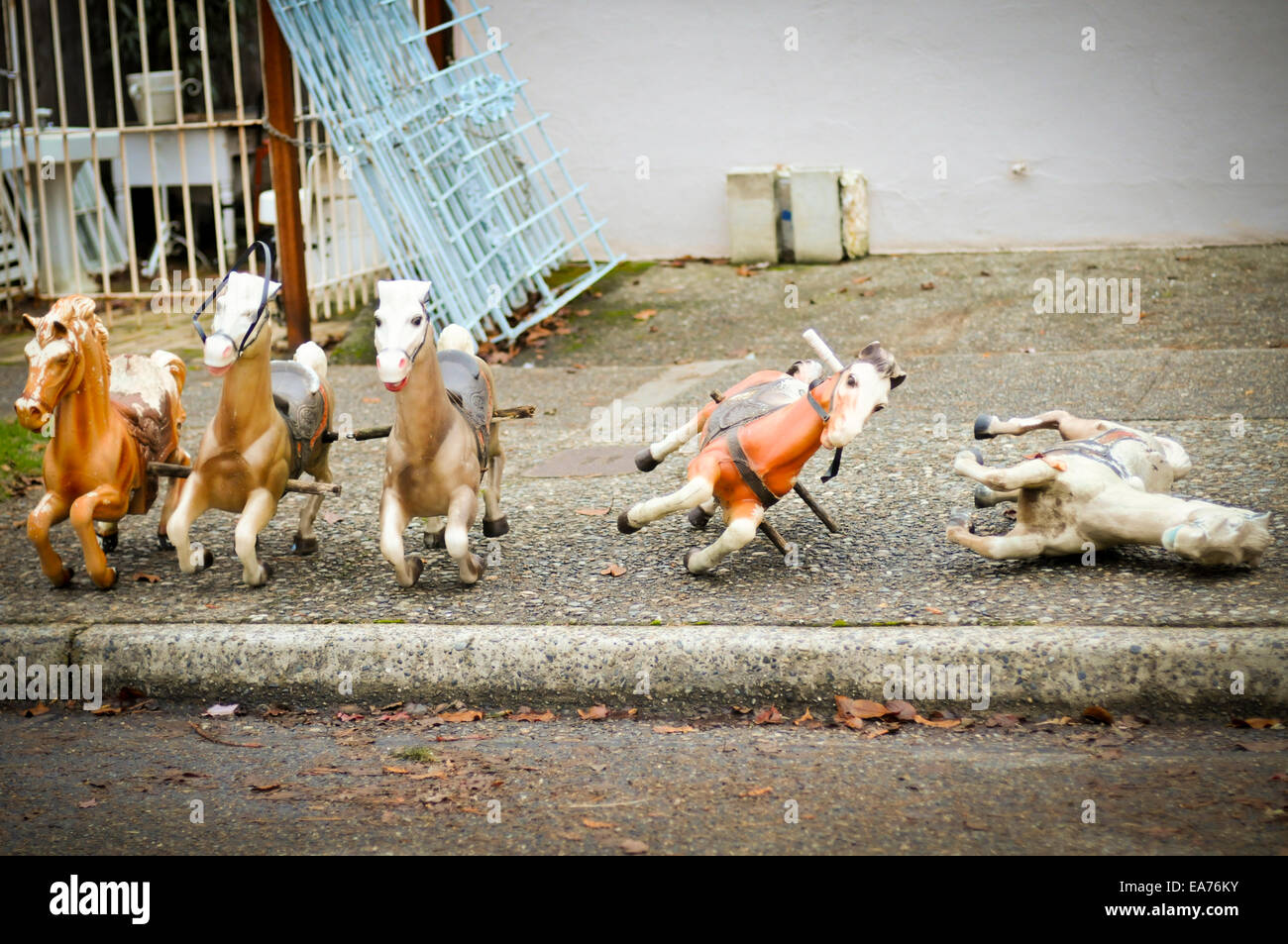 Rocking horses on sidewalk Stock Photo - Alamy