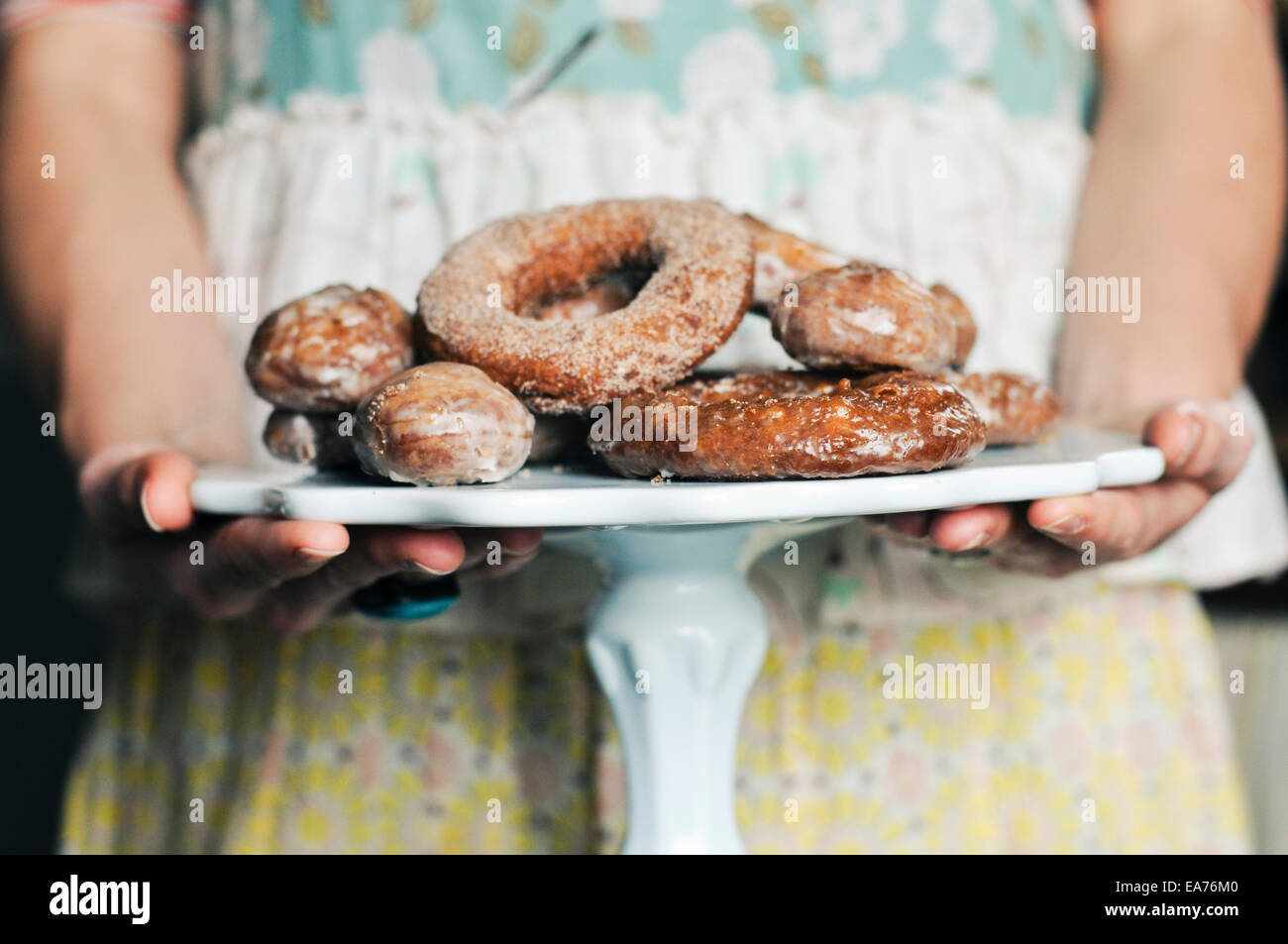 Woman holding plate full of cookies Stock Photo - Alamy