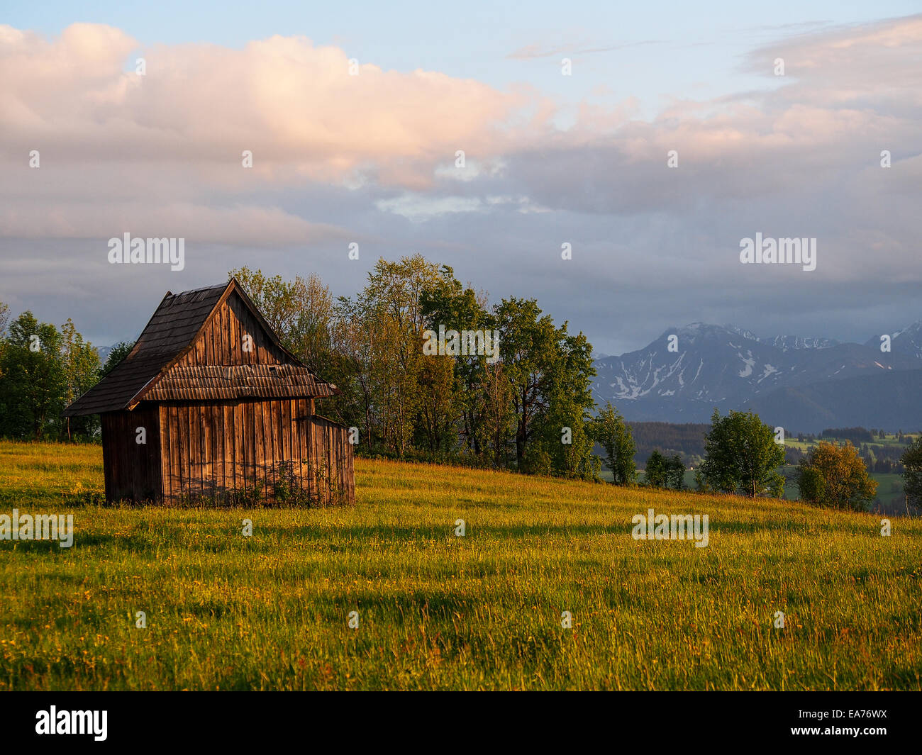 Summer sunrise mountain village outskirts view and Tatra range behind ...