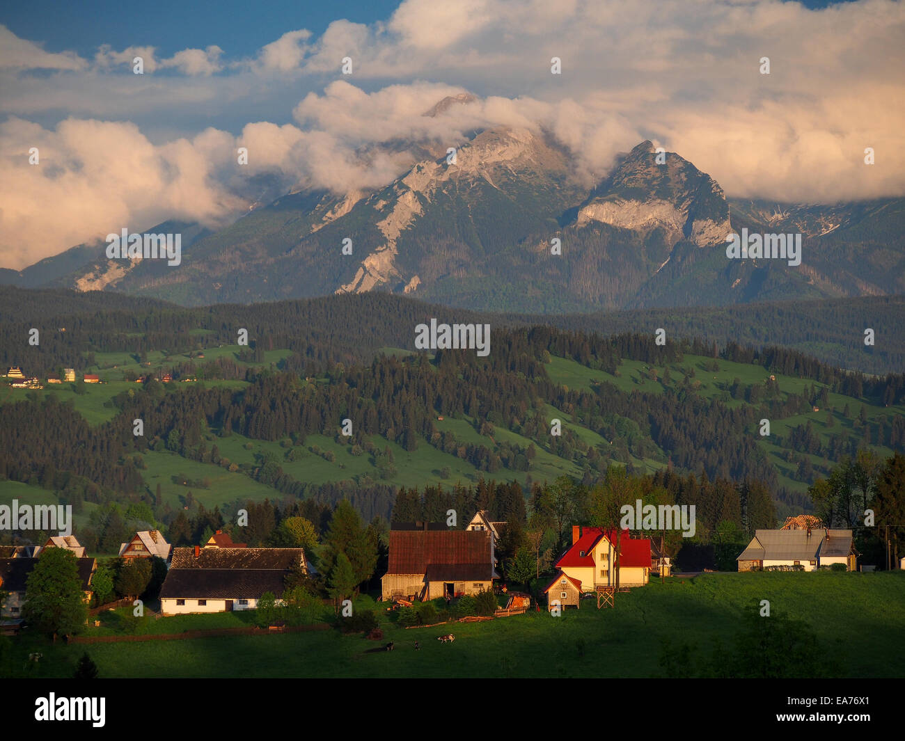 Summer sunrise mountain village outskirts view and Tatra range behind ...