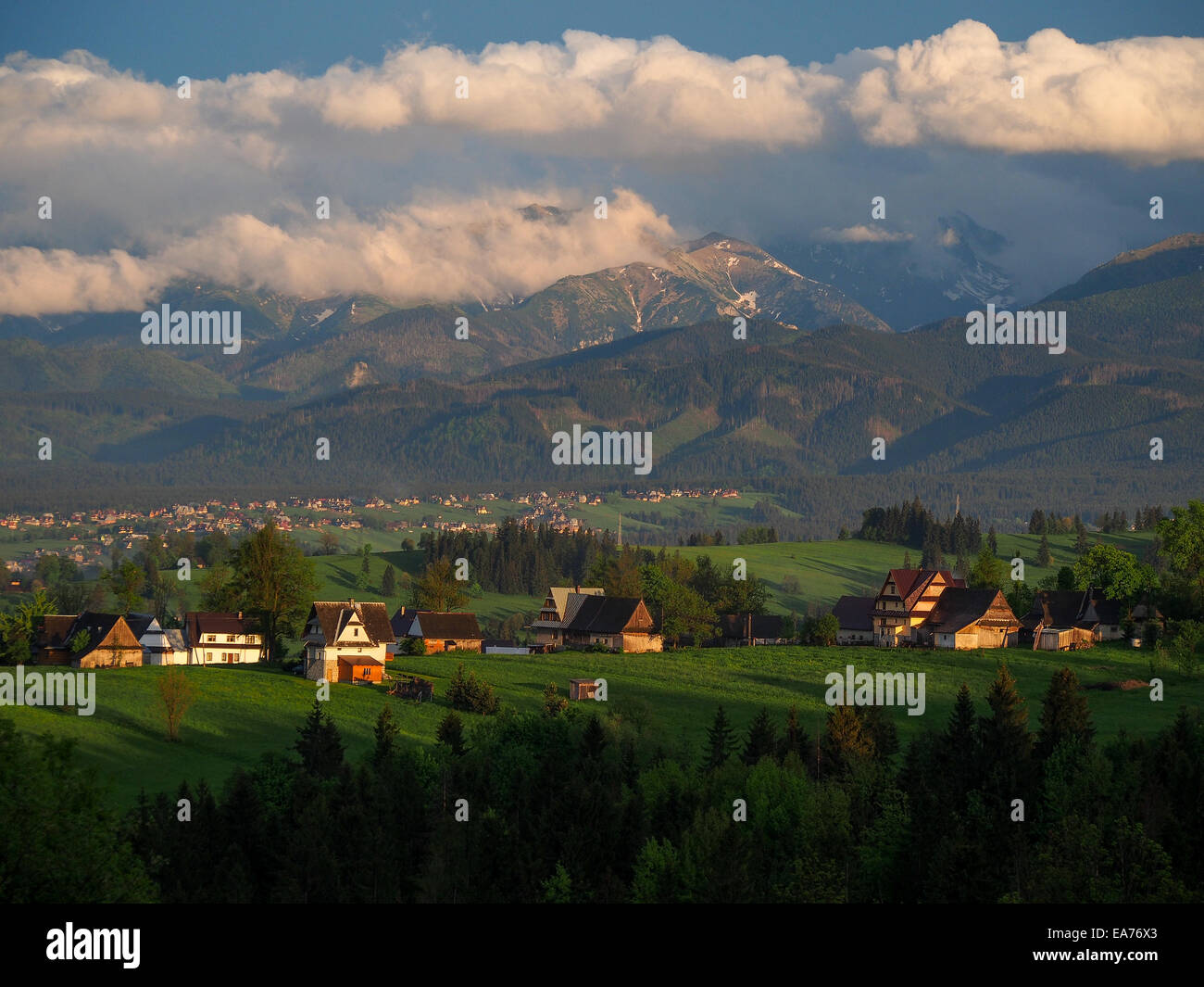 Summer sunrise mountain village outskirts view and Tatra range behind ...