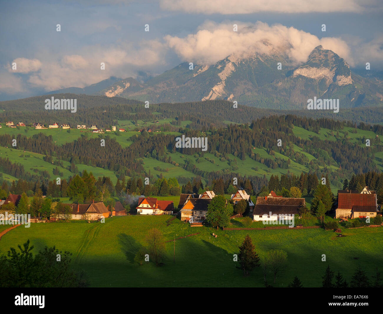 Summer sunrise mountain village outskirts view and Tatra range behind ...