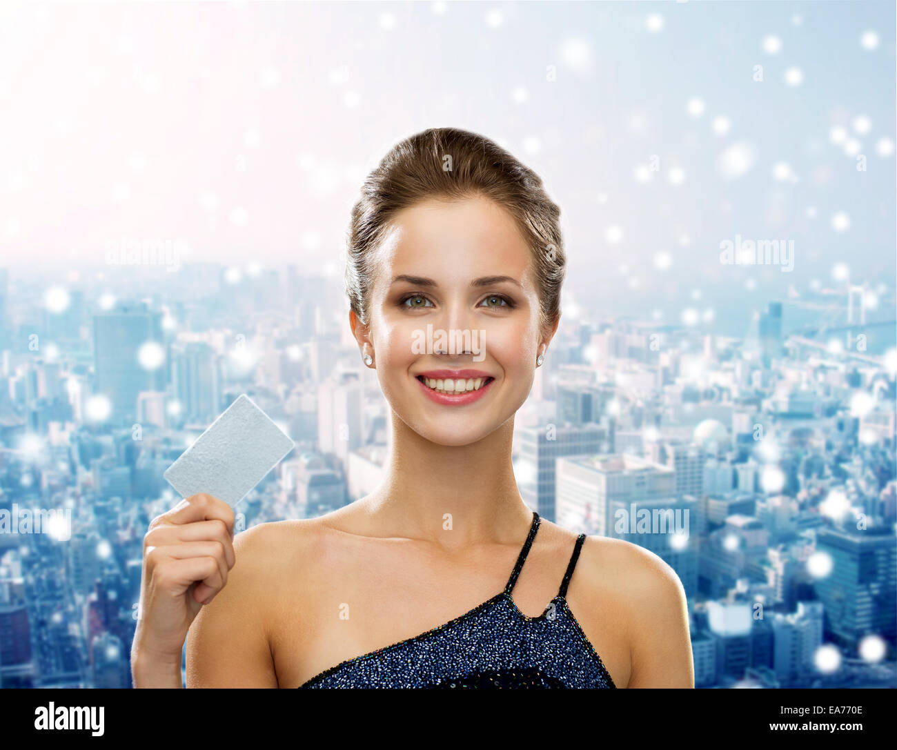 smiling woman in evening dress holding credit card Stock Photo - Alamy