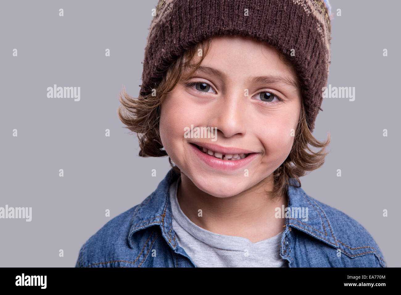 Little fashion boy posing over grey background Stock Photo - Alamy