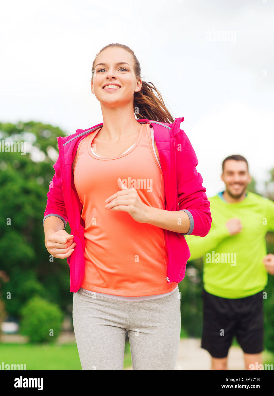 smiling couple running outdoors Stock Photo - Alamy