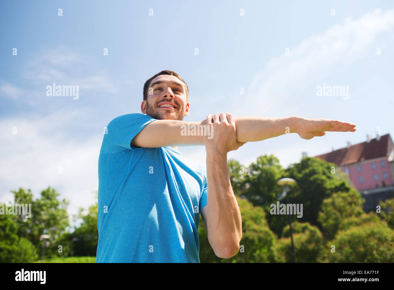 smiling man stretching outdoors Stock Photo - Alamy