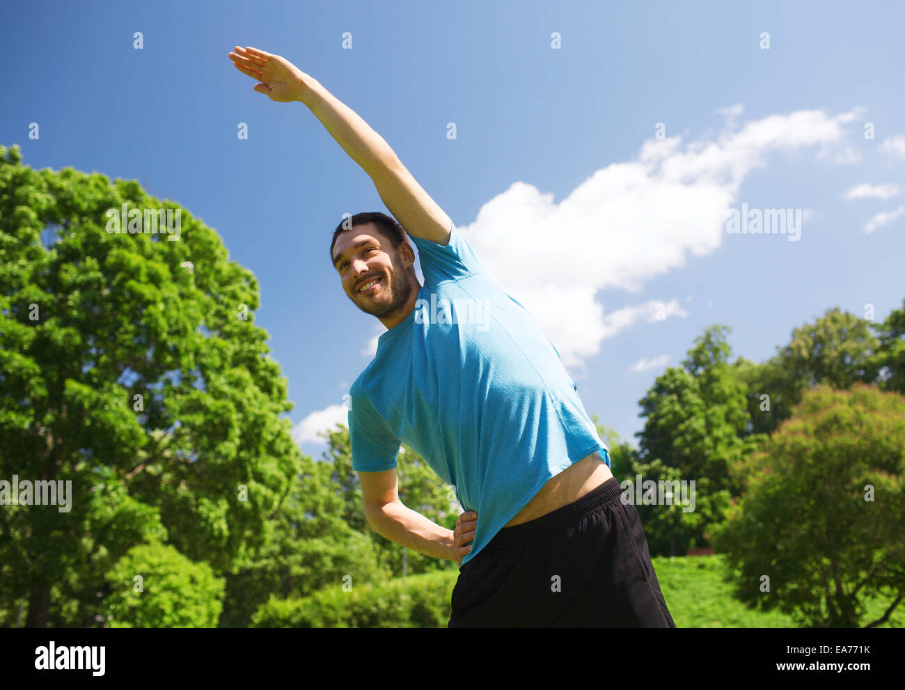 smiling man stretching outdoors Stock Photo - Alamy