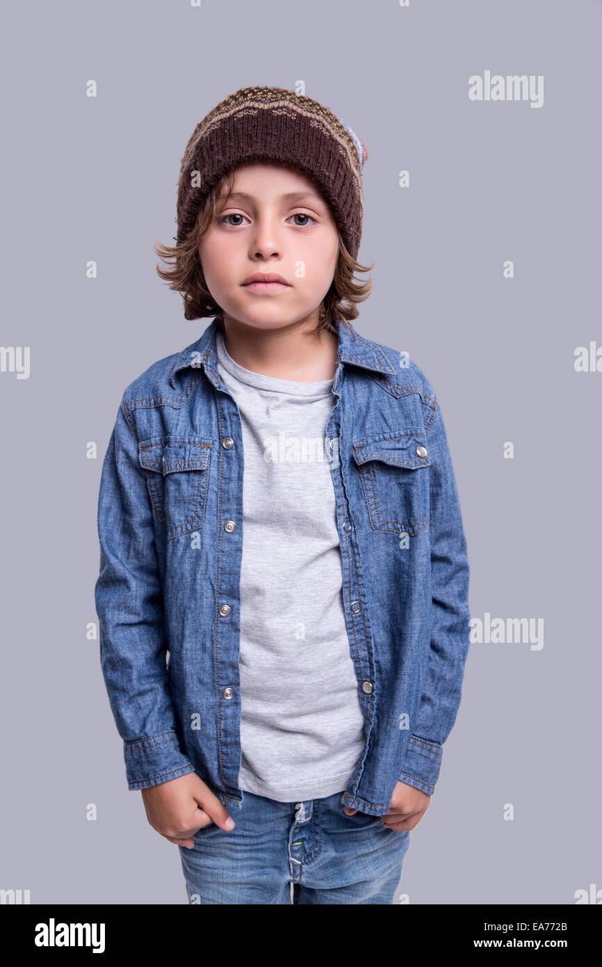 Little fashion boy posing over grey background Stock Photo - Alamy