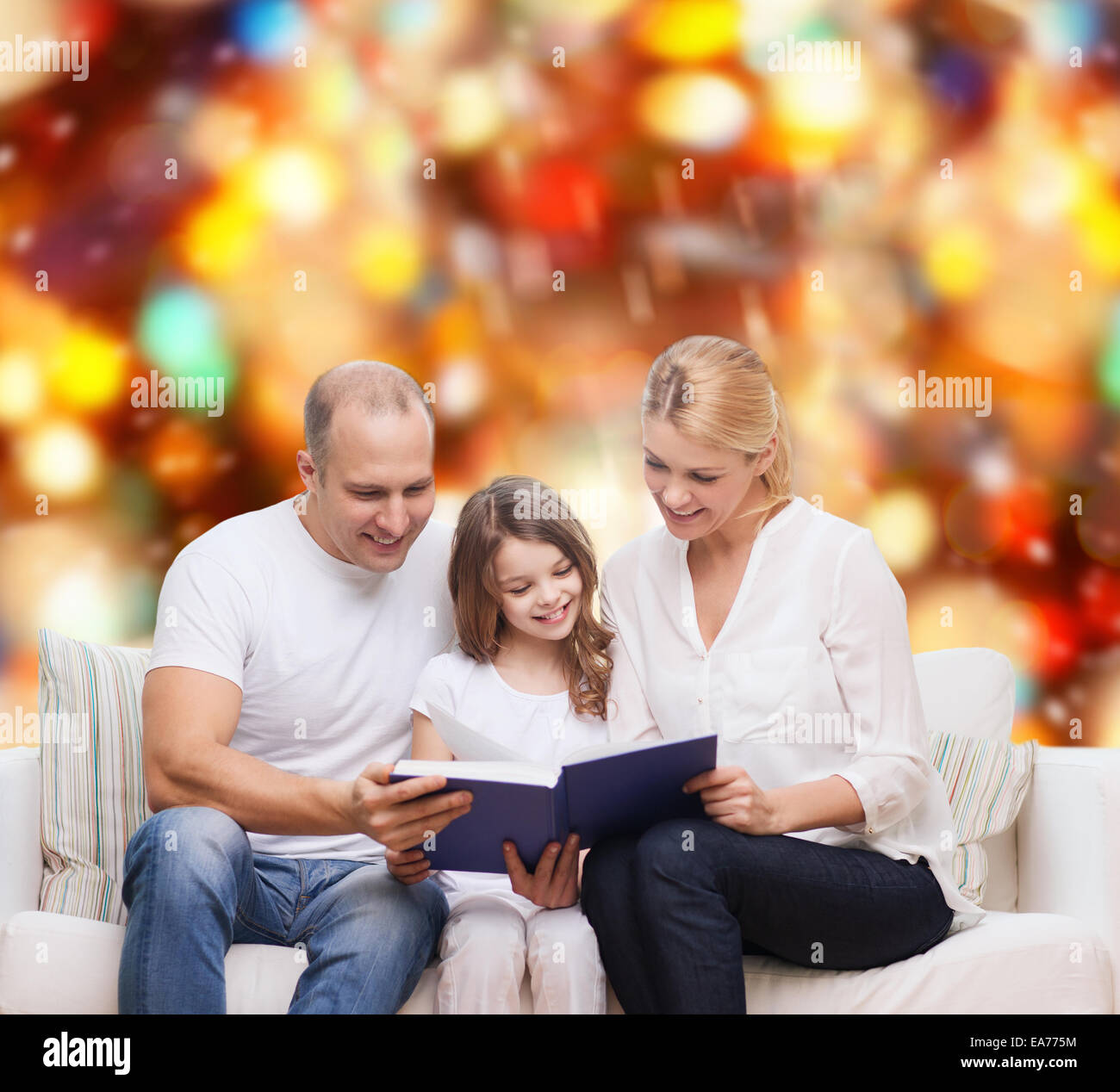 happy family with book at home Stock Photo - Alamy