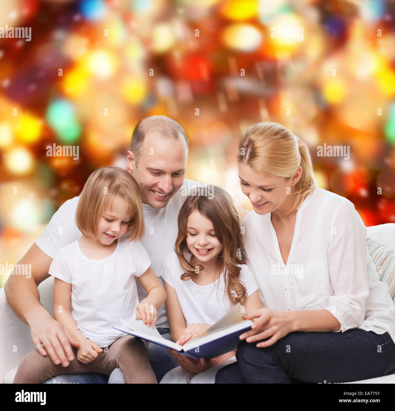 happy family with book at home Stock Photo - Alamy