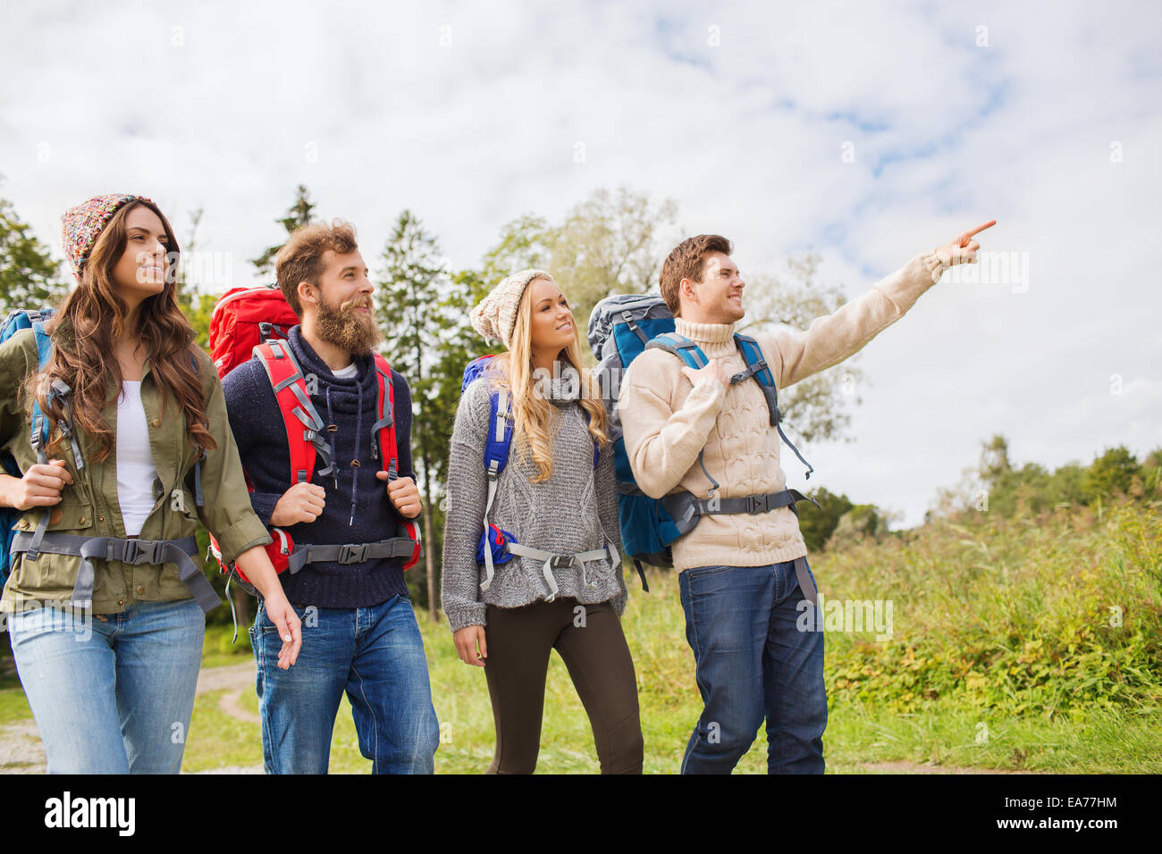 group of smiling friends with backpacks hiking Stock Photo - Alamy
