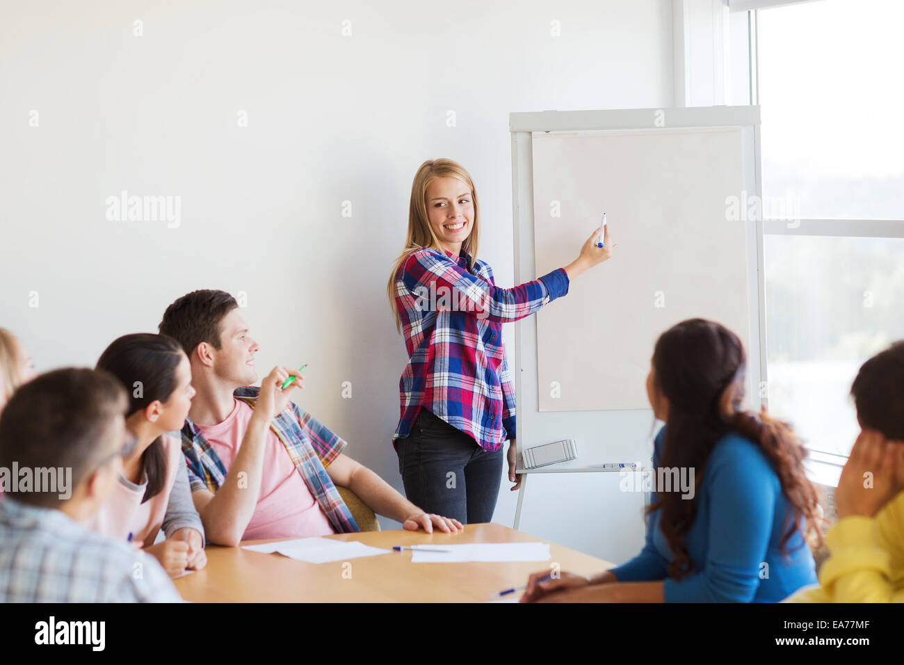 group of smiling students with white board Stock Photo - Alamy