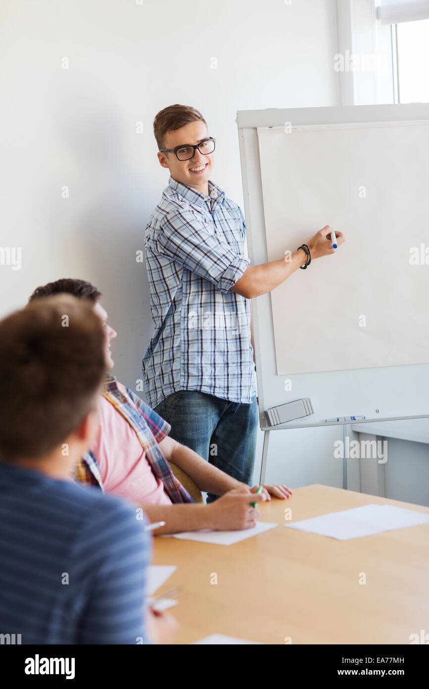 group of smiling students with white board Stock Photo - Alamy