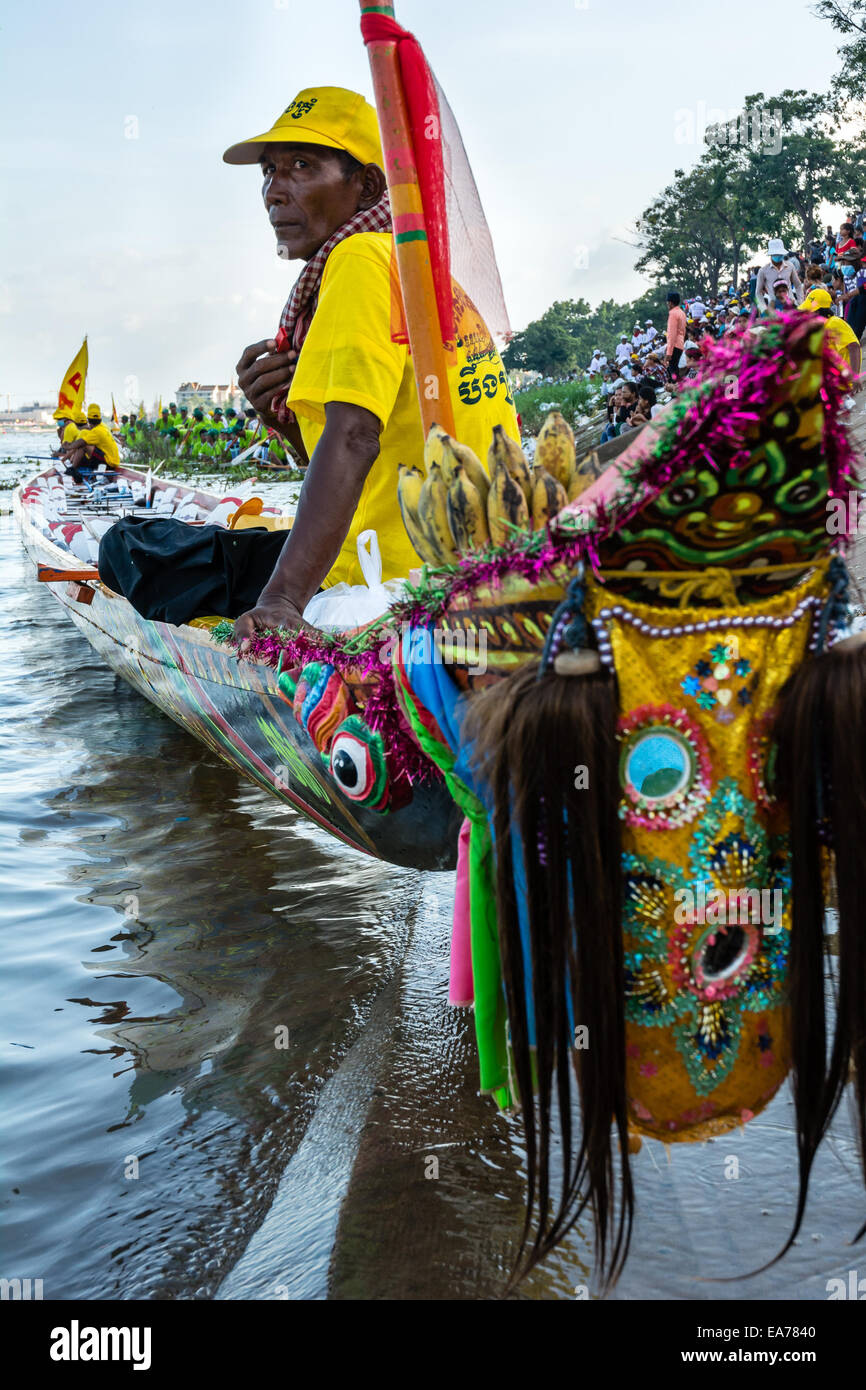 An oarsman gets ready to blow a whistle to call his pirogue crew to ...