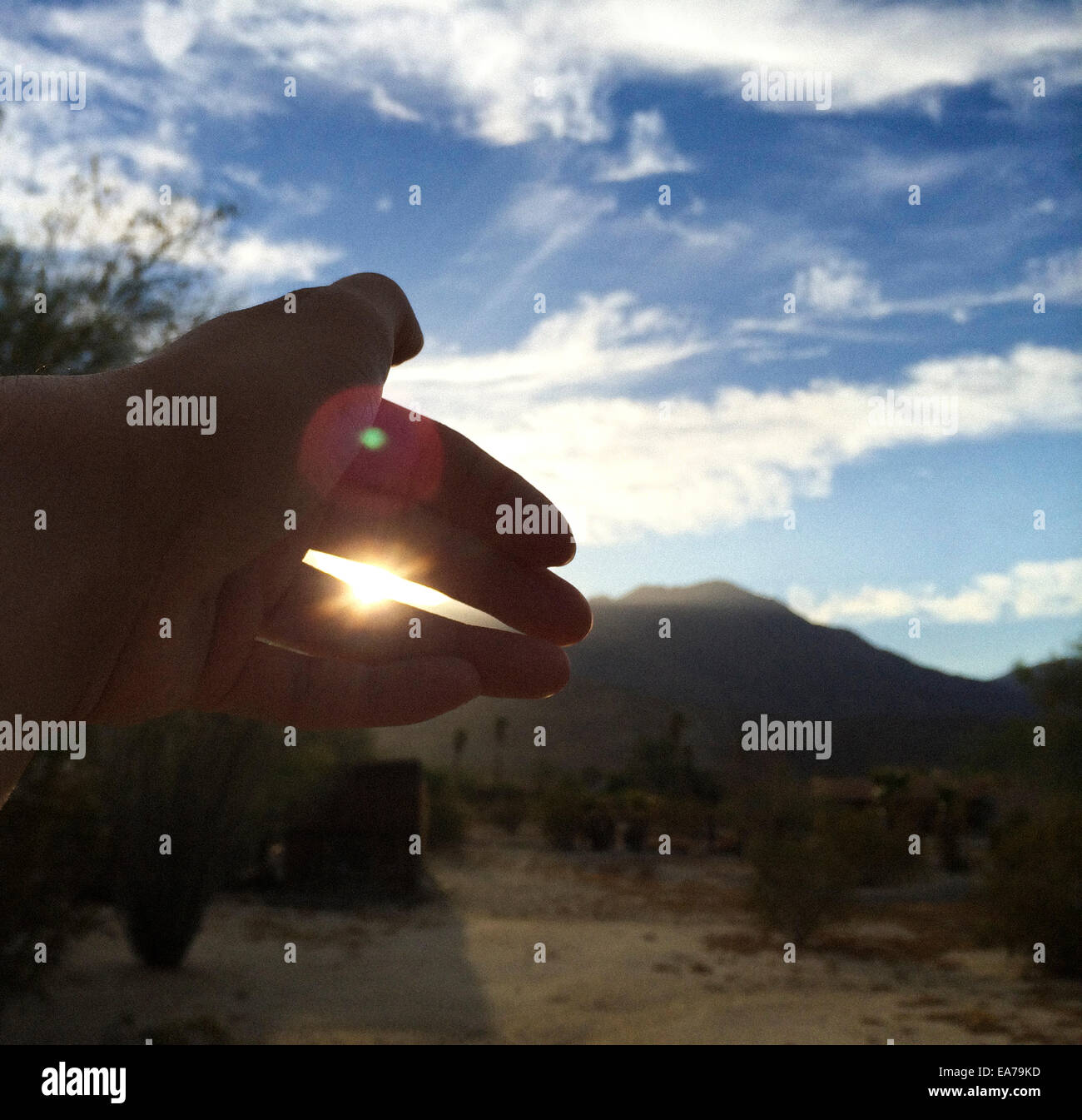 Human hand against sunrise in mountains Stock Photo - Alamy