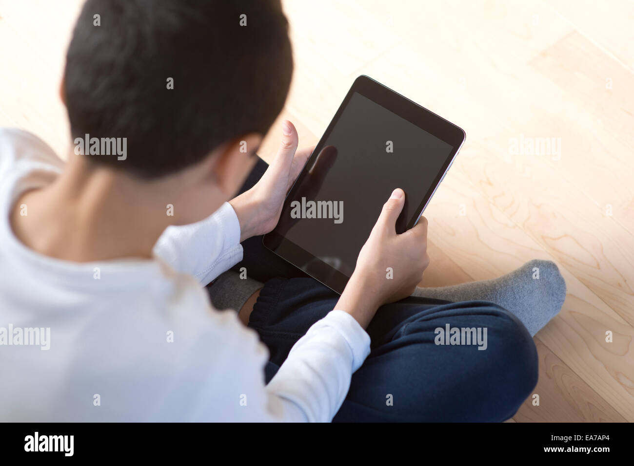 Young boy sitting with ipad tablet computer Stock Photo - Alamy