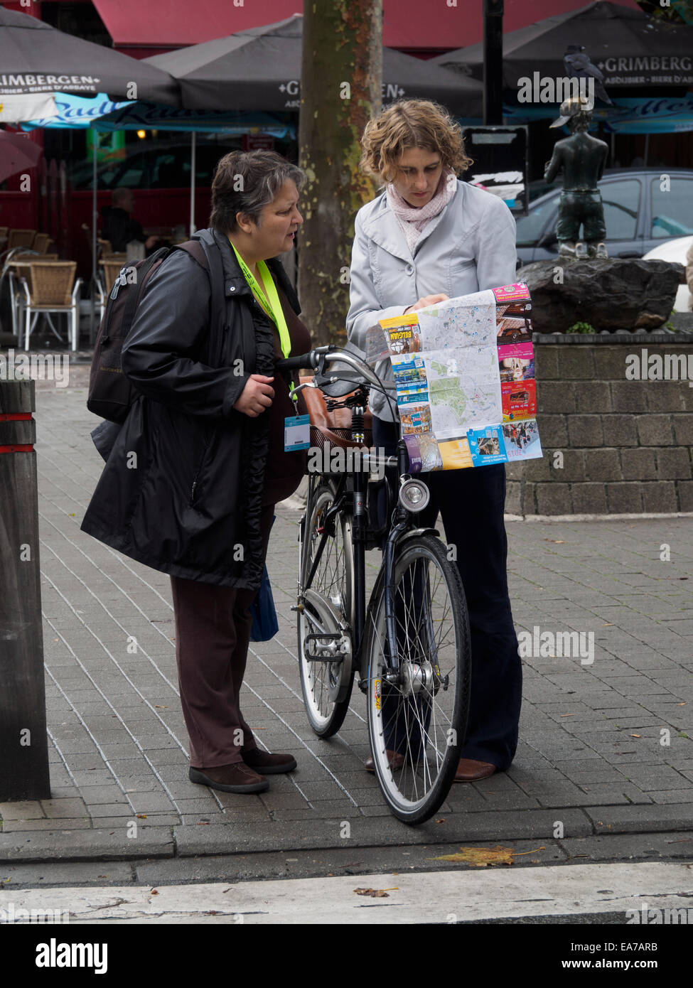 Tourist holding map and asking for directions in the streets of ...