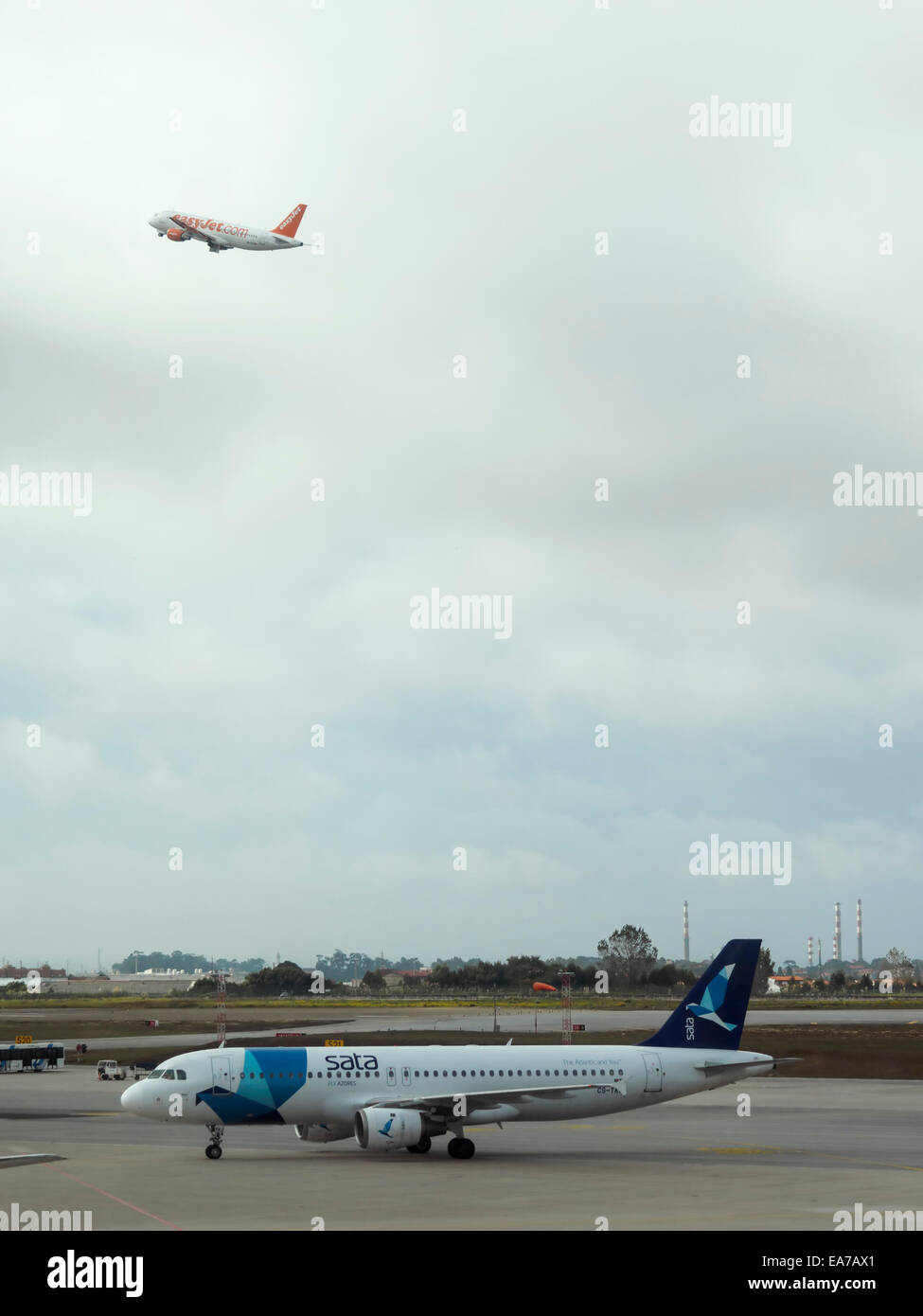 easyJet airplane taking off while a SATA aircraft waits for its turn on ...