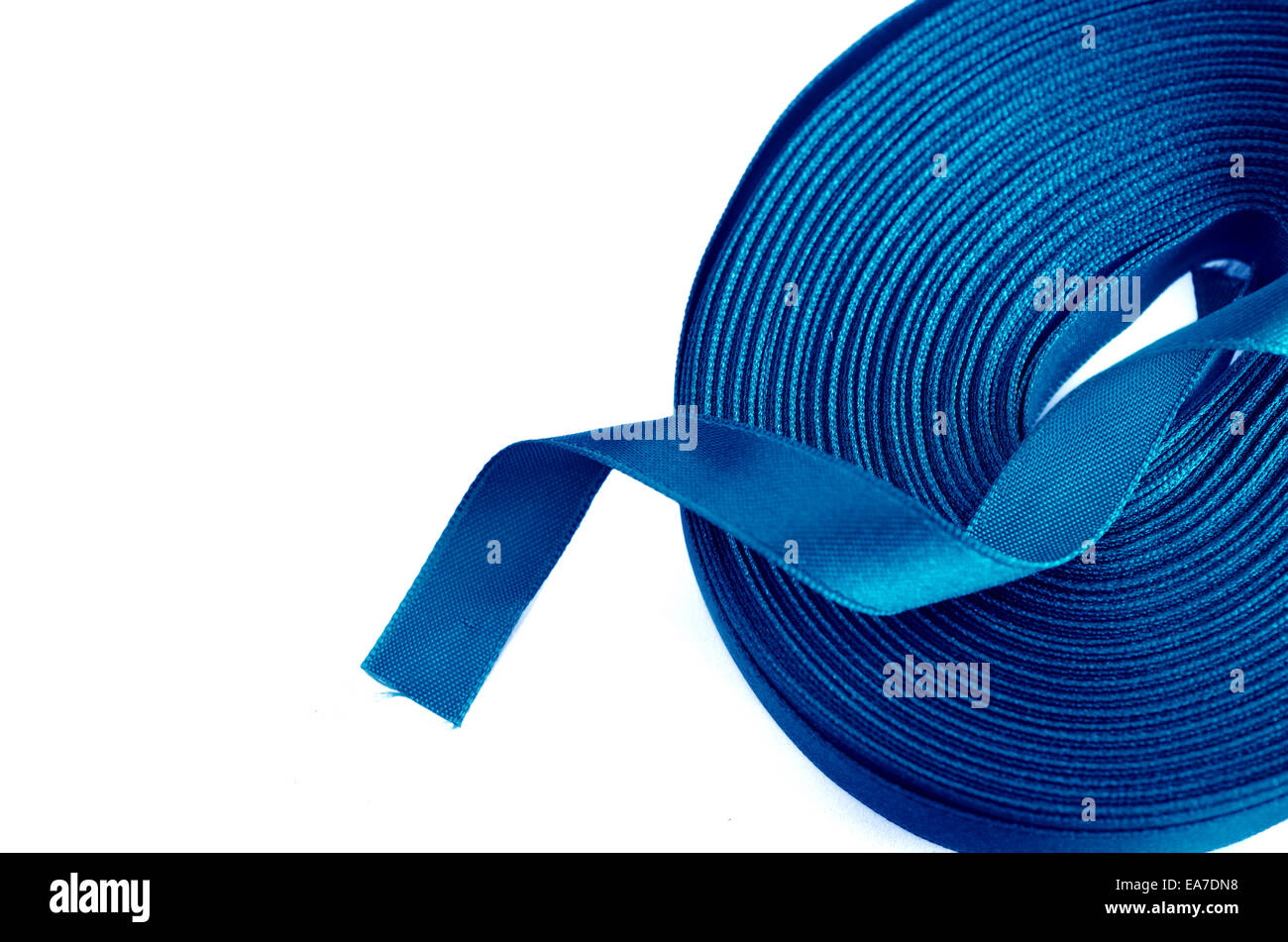Blue ribbon roll on a white background Stock Photo - Alamy