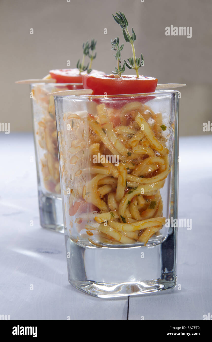 sweet chilli noodle appetizer with thyme and tomato in a shot glass ...