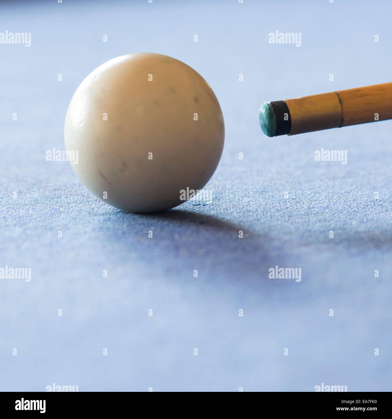 Pool cue and the white ball in shallow focus on a pool table Stock ...