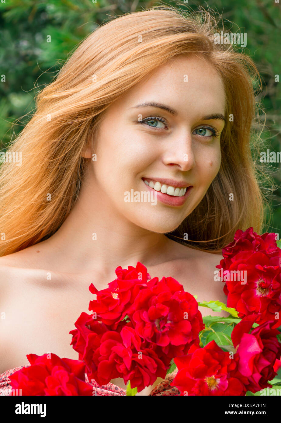 Girl with roses outdoors smiling Stock Photo - Alamy
