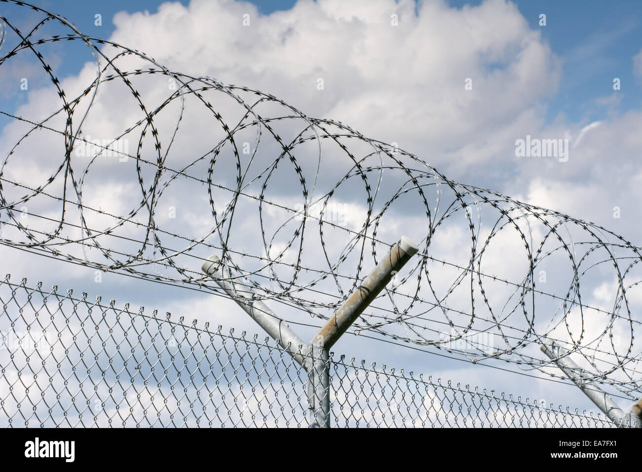 Security barrier with a barbed wire fence Stock Photo - Alamy