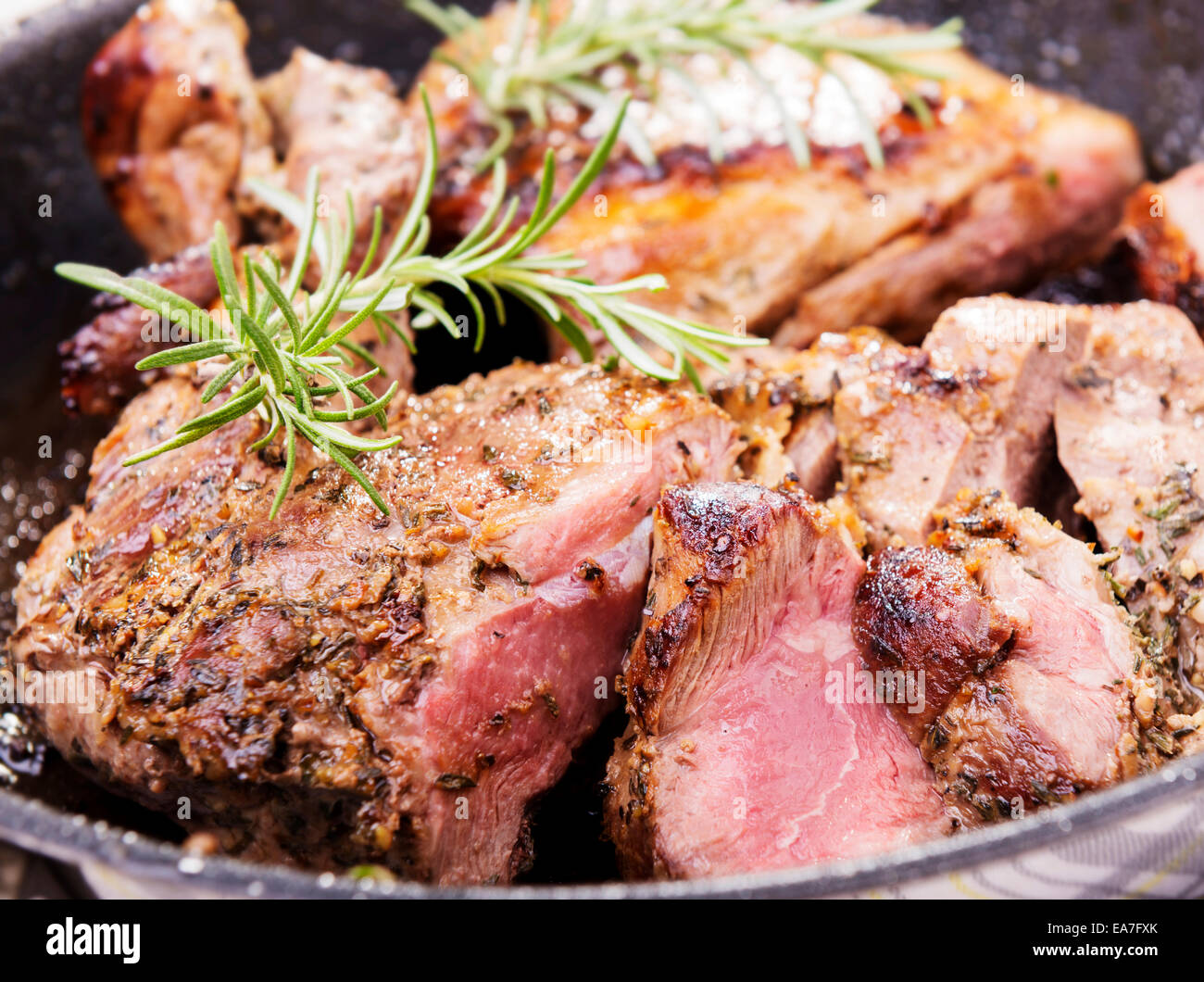 Rustic roast lamb with pan juices and rosemary Stock Photo - Alamy