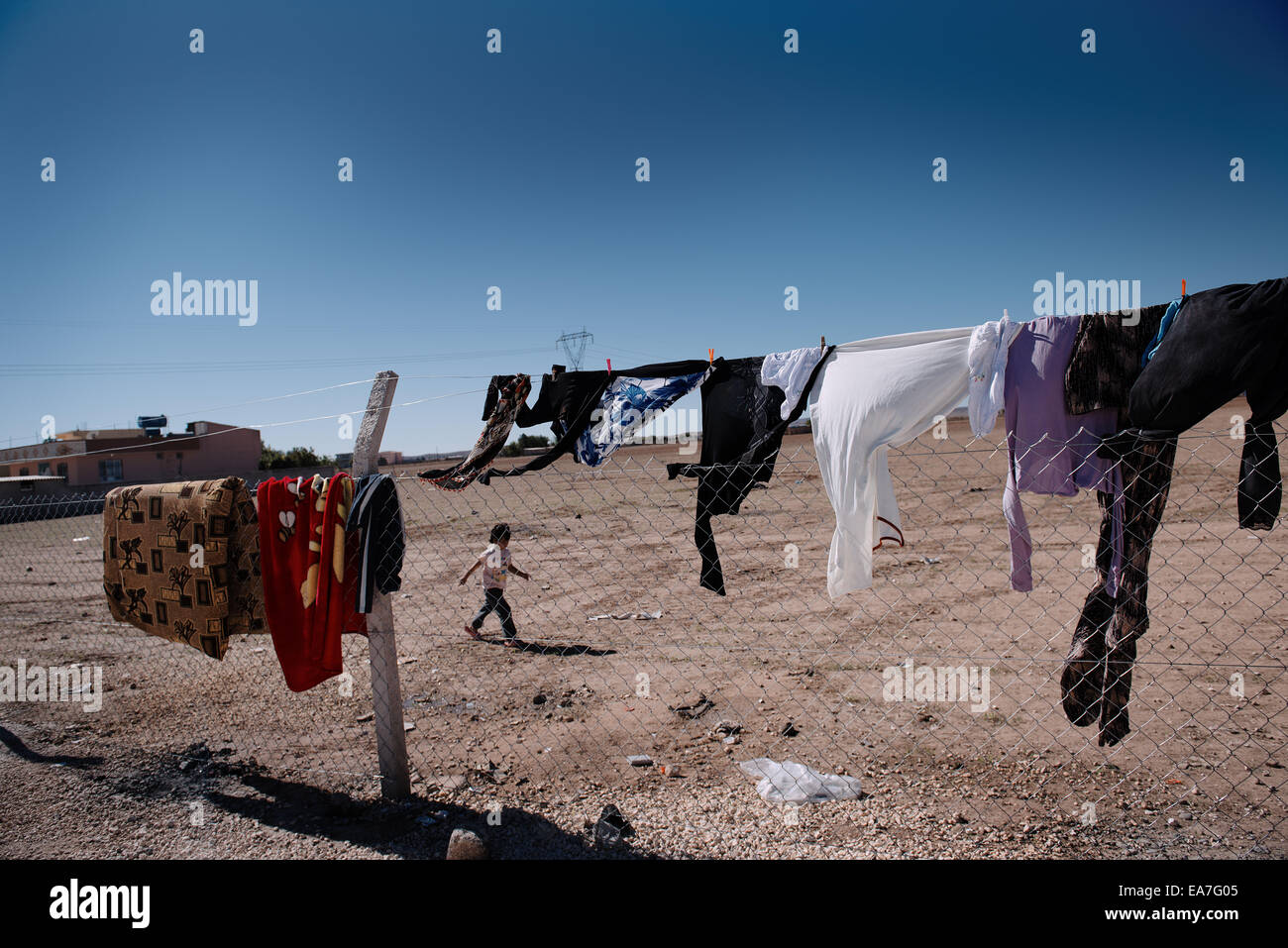 A Kurdish refugee child in a refugee camp in Suruc near the Turkish and ...