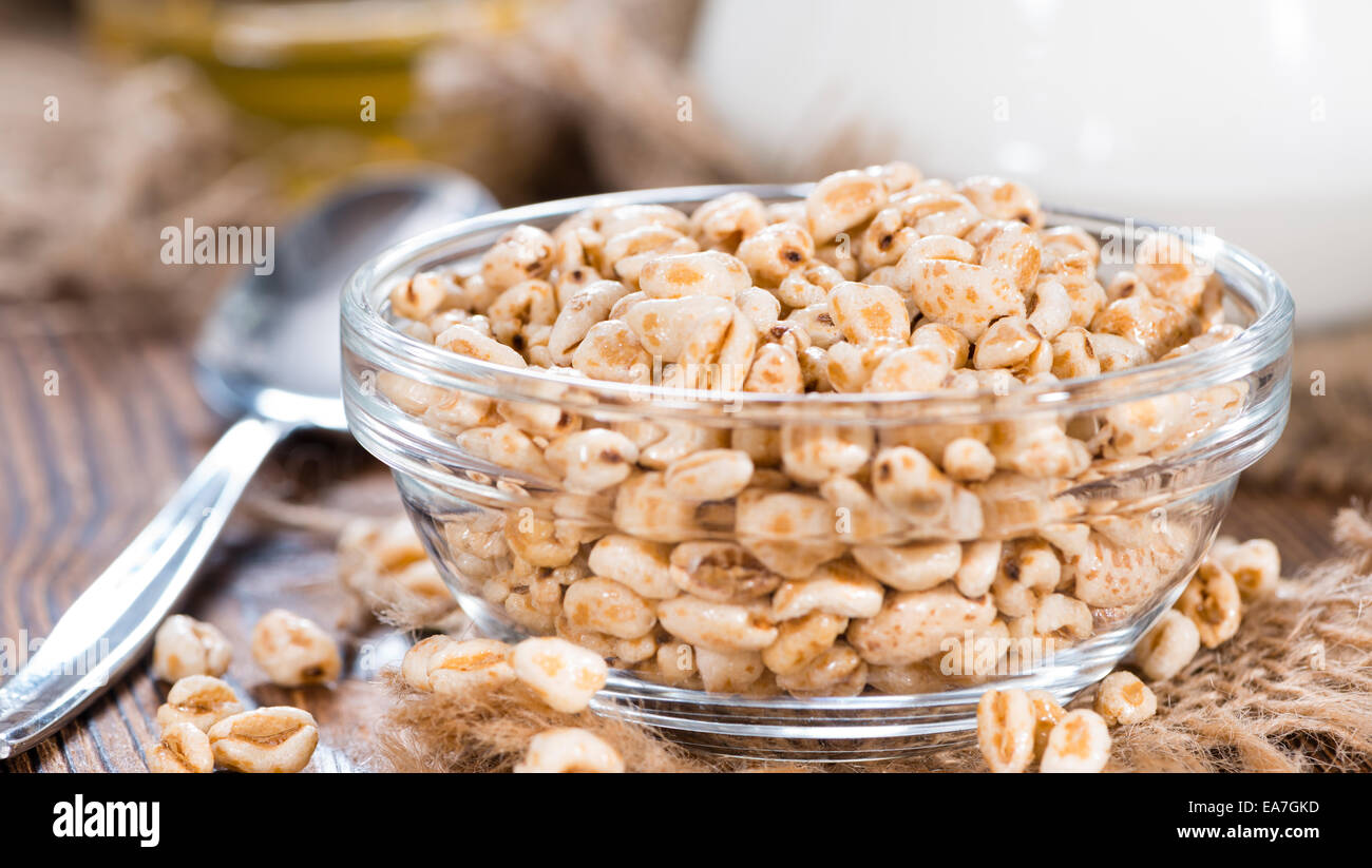 Puffed wheat breakfast cereals with honey and milk Stock Photo - Alamy