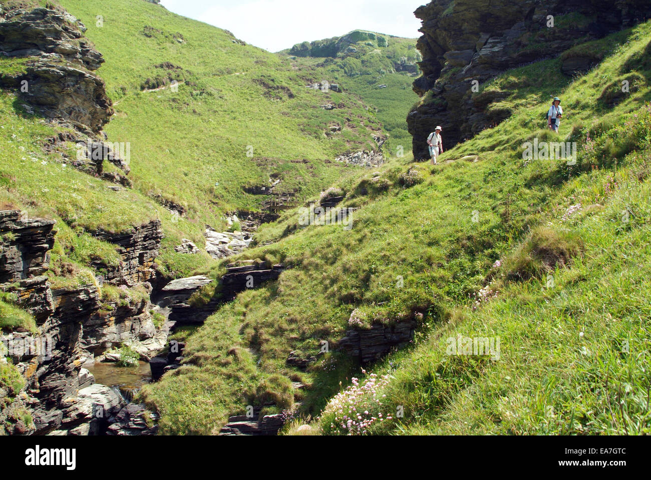 Couple walking on path through Rocky Valley on the coast between ...