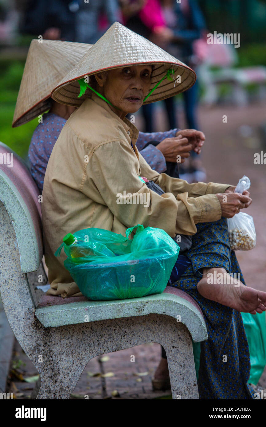 Street vendors rest their feet in Hanoi, Vietnam Stock Photo - Alamy