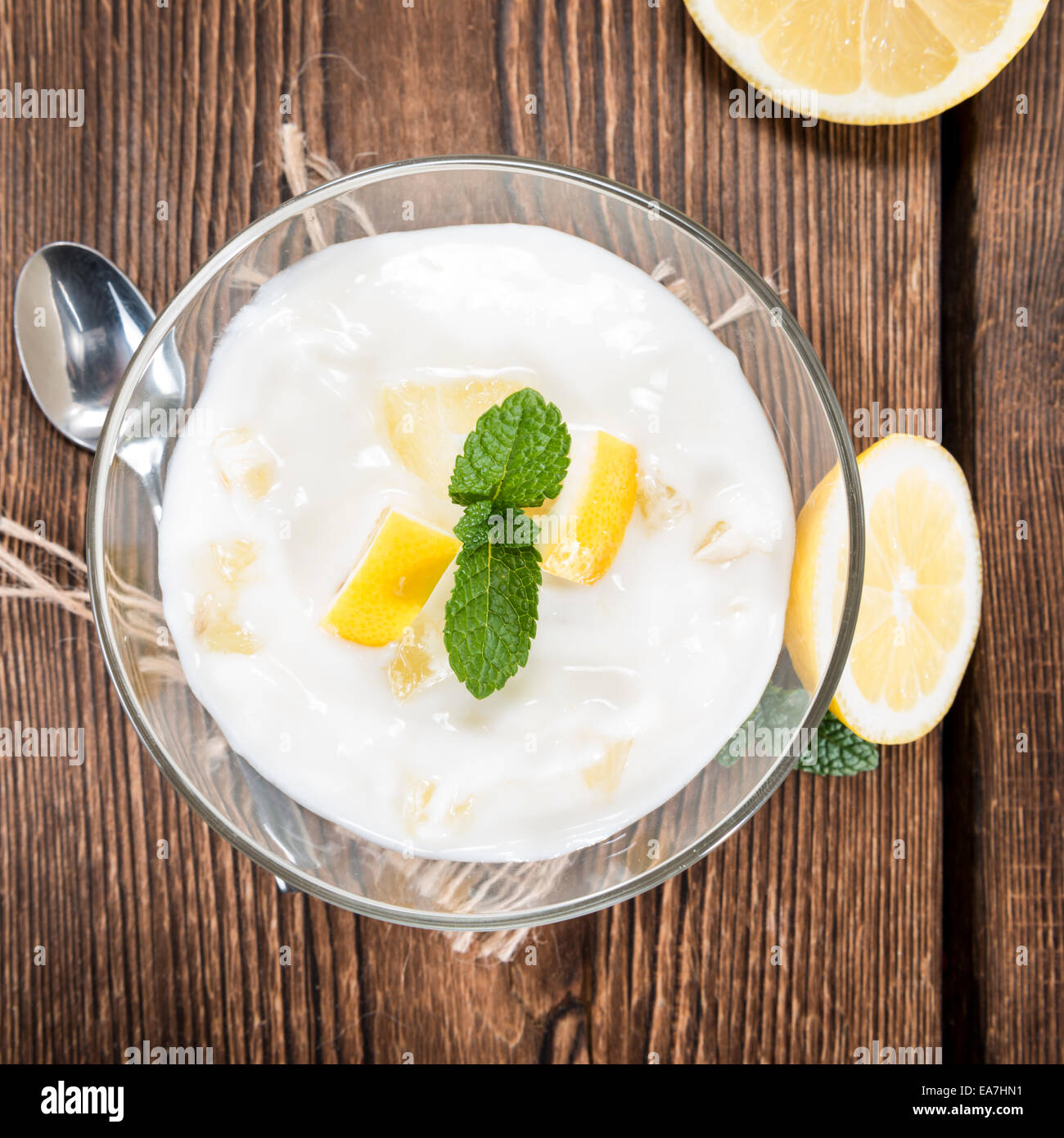 Portion of fresh homemade Lemon Yoghurt on wooden background (with some ...