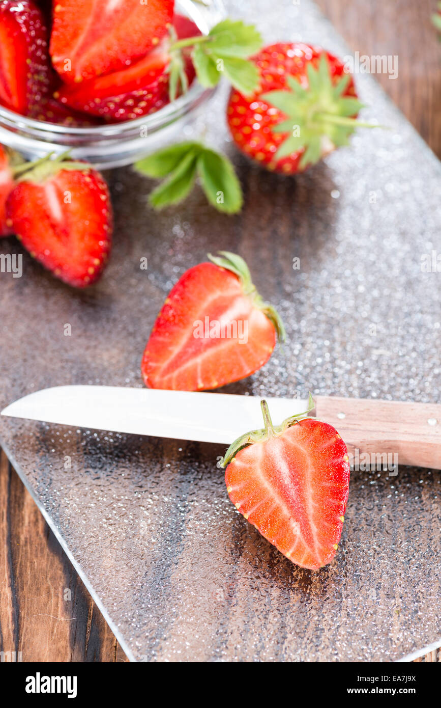 Portion of Strawberry Pieces with some fresh fruits (close-up shot ...