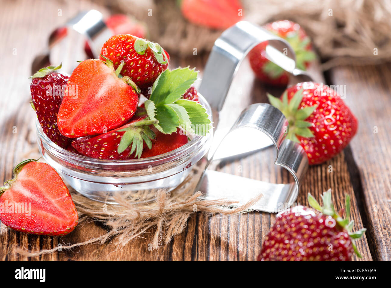 Portion of Strawberry Pieces with some fresh fruits (close-up shot ...