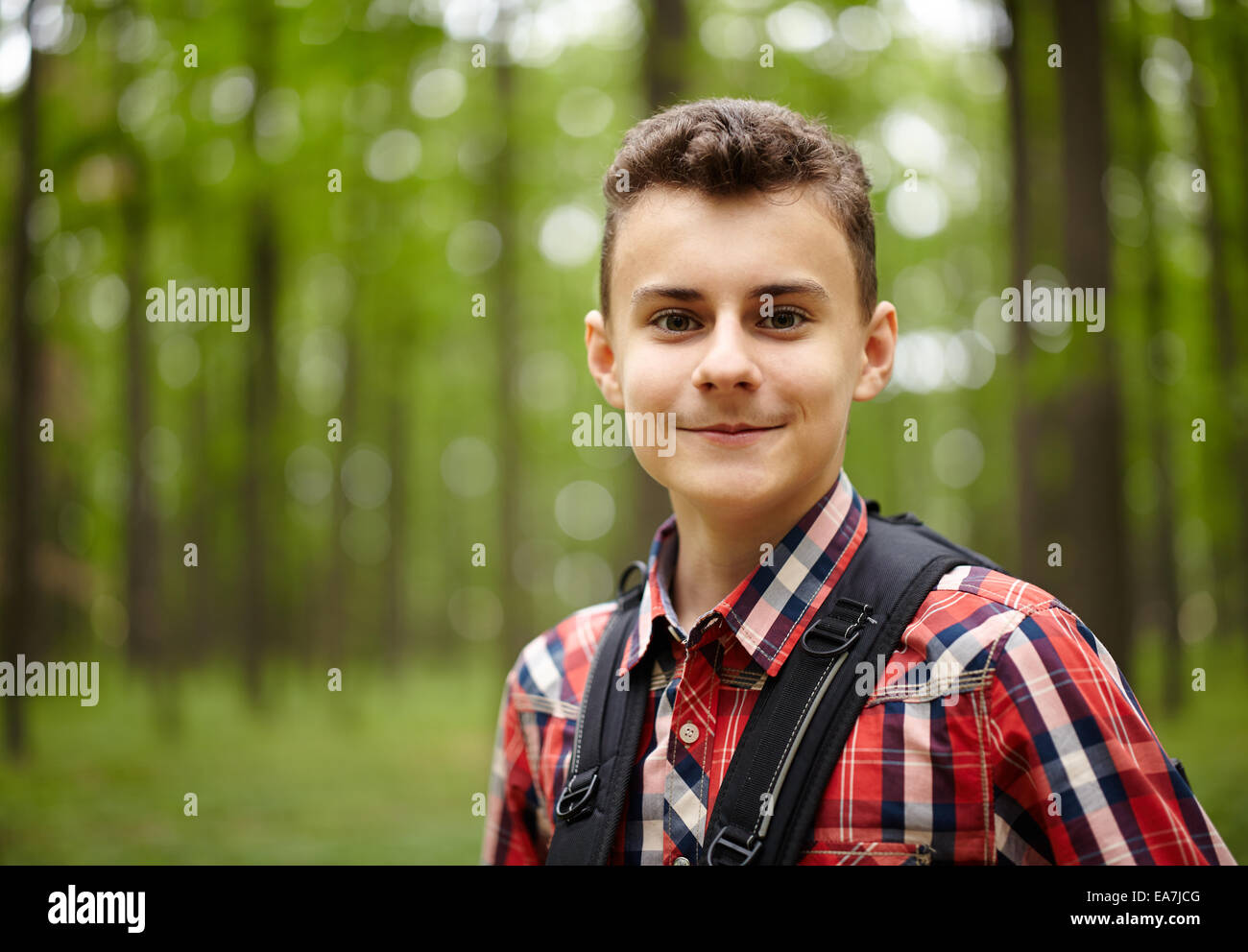 Trendy caucasian teenager boy with school bag outdoor Stock Photo - Alamy