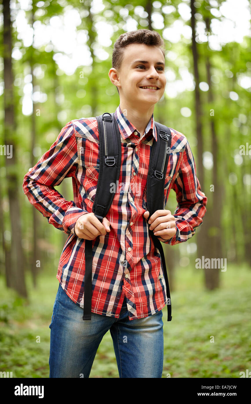 Trendy caucasian teenager boy with school bag outdoor Stock Photo - Alamy