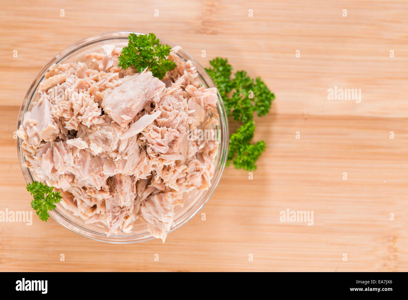 Portion of Tuna with fresh parsly on wooden background Stock Photo - Alamy