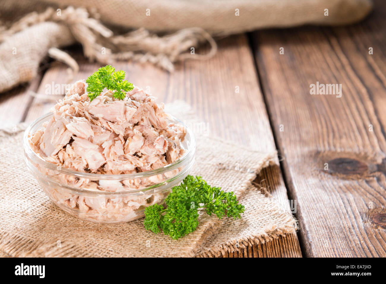Portion of (canned) Tuna with fresh herbs as detailed close-up shot ...