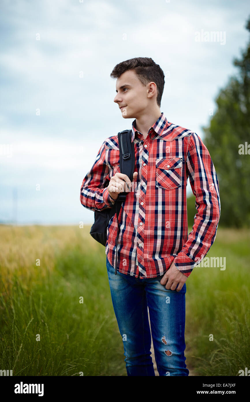 Trendy caucasian teenager boy with school bag outdoor Stock Photo - Alamy