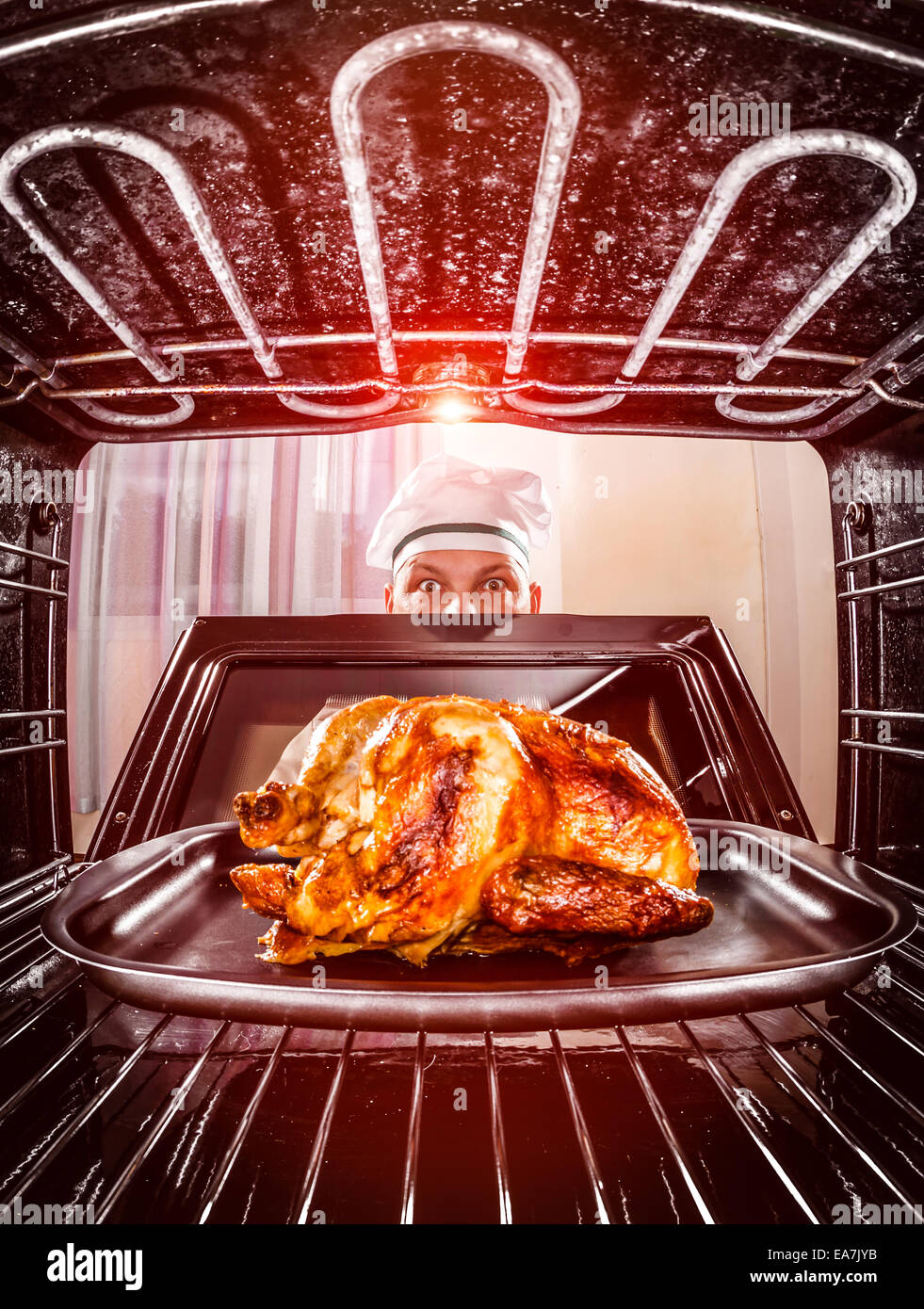 Chef prepares roast chicken in the oven, view from the inside of the ...