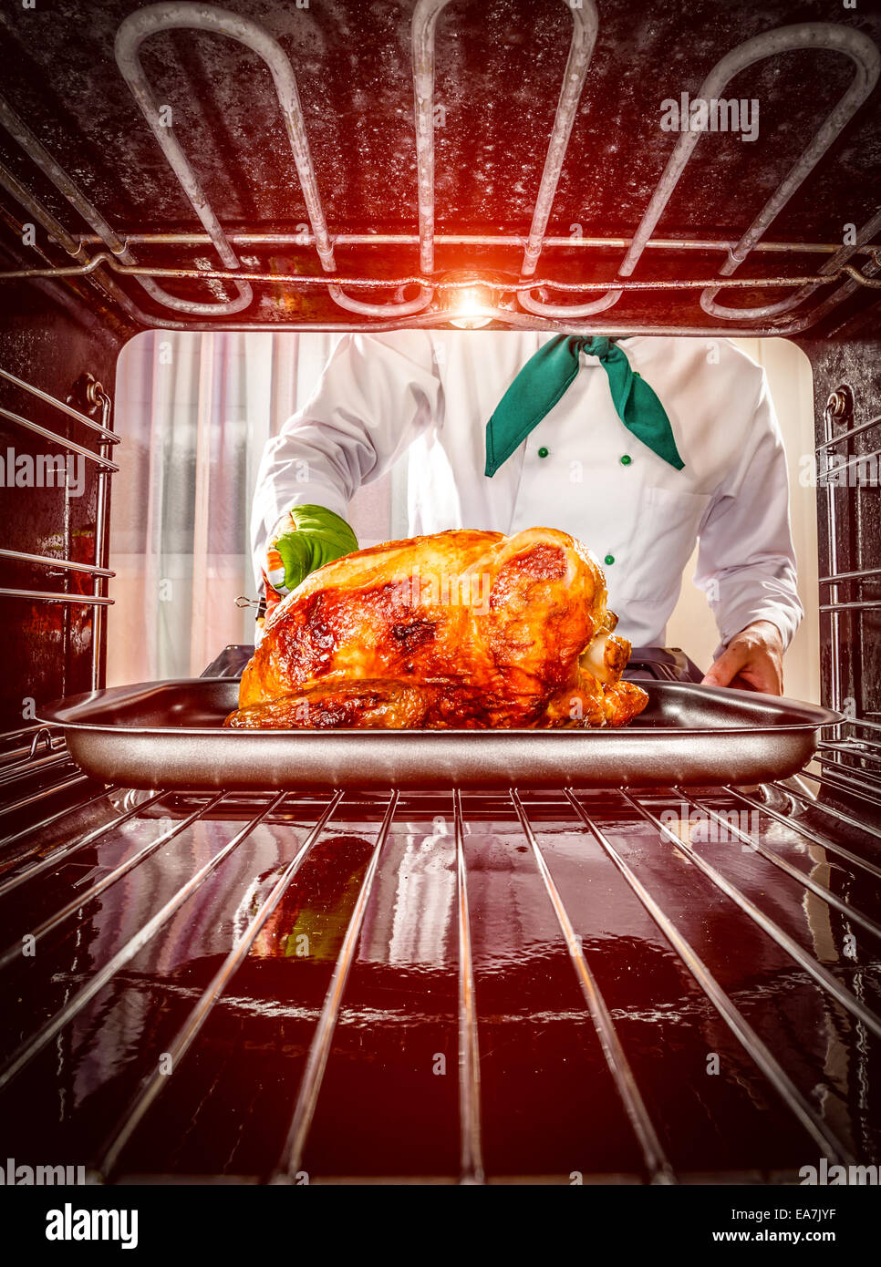 Chef prepares roast chicken in the oven, view from the inside of the ...