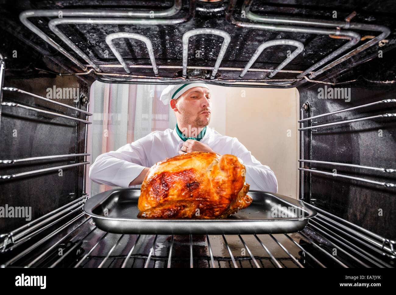 Chef prepares roast chicken in the oven, view from the inside of the ...