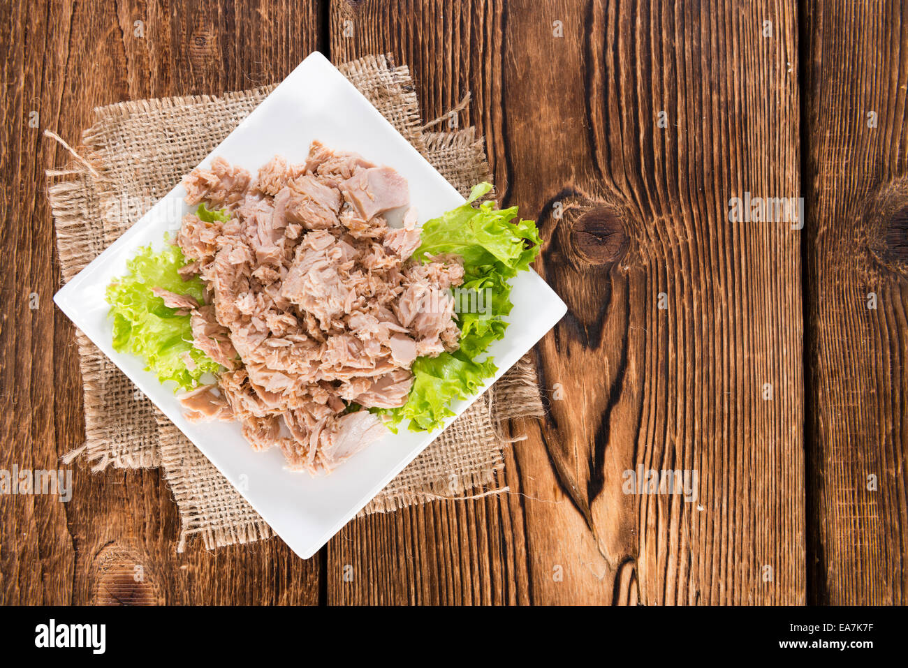 Portion of (canned) Tuna with fresh herbs as detailed close-up shot ...