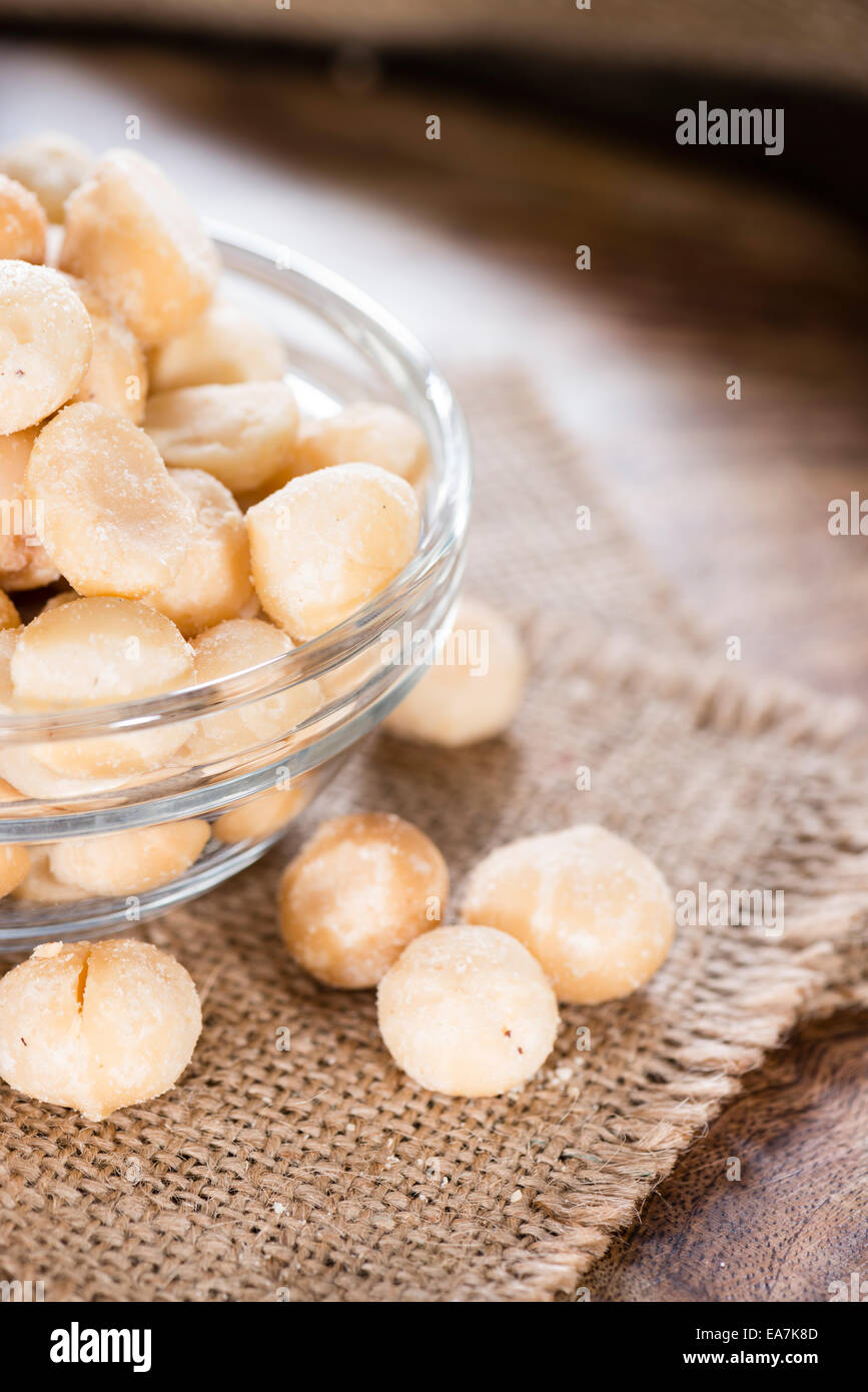 Roasted and salted Macadamia nuts on rustic wooden background Stock ...