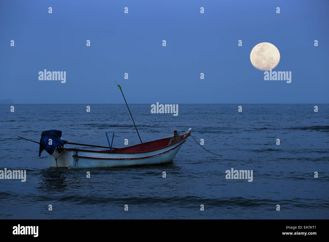 Fishing boat on the night of the full moon Stock Photo - Alamy