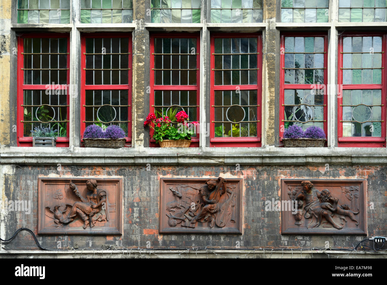 Ornate carved frontage and colured leaded windows on a traditional ...